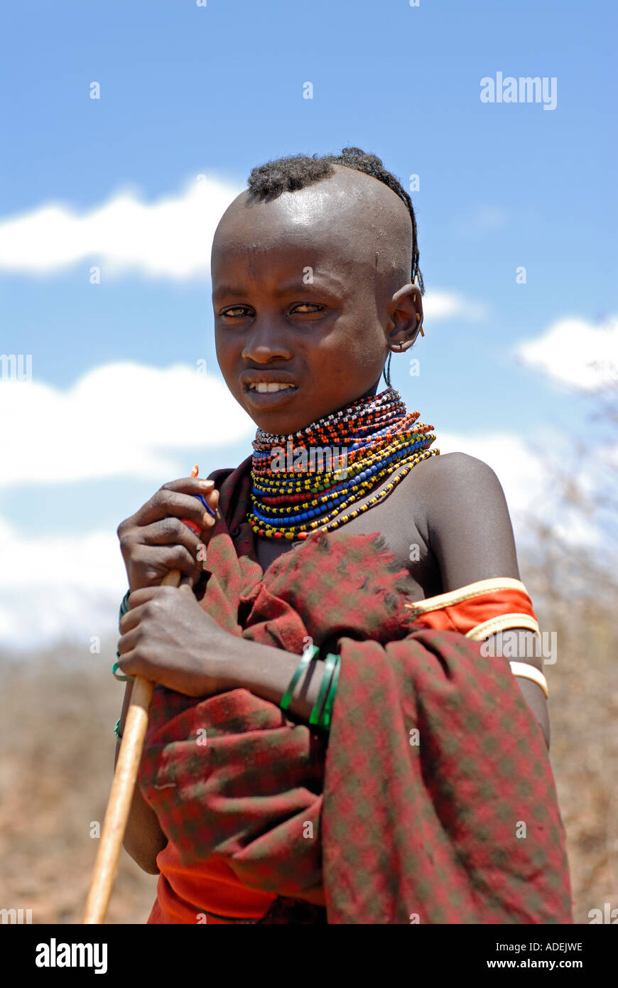 Little Turkana boy wearing typical tribal hairstyle and bead ornaments ...