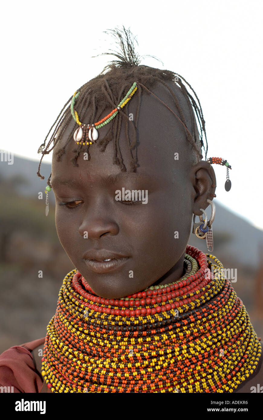 Turkana girl with traditional hairstyle and elaborated bead necklaces ...