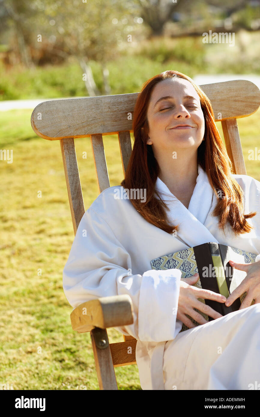 Mature woman reclining in an armchair with her eyes closed Stock Photo ...