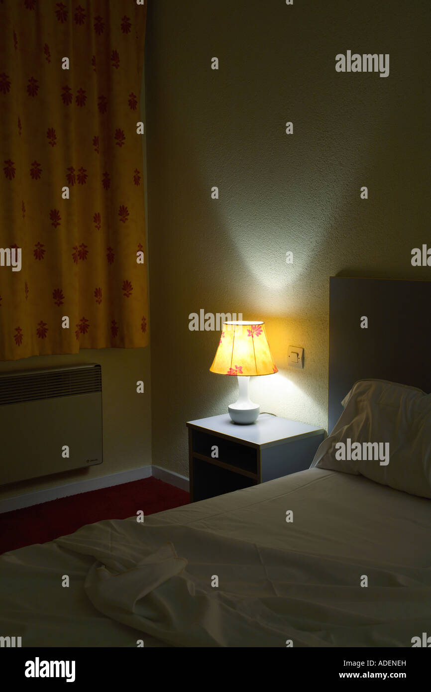 empty motel room with bed and lamp at night Stock Photo - Alamy
