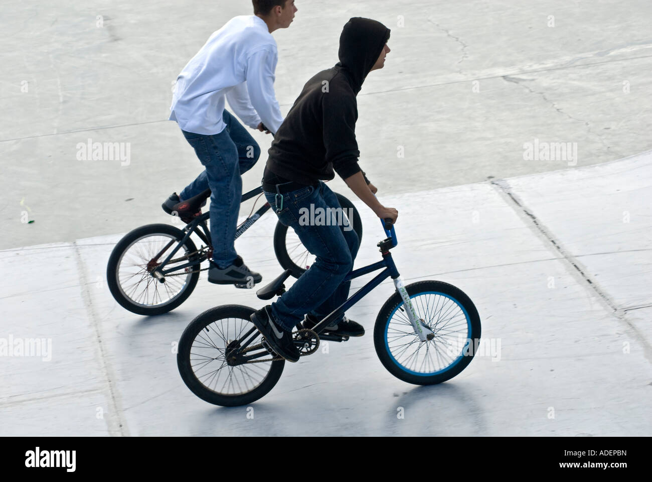 two boys youths riding bikes hoody [side view] Stock Photo - Alamy