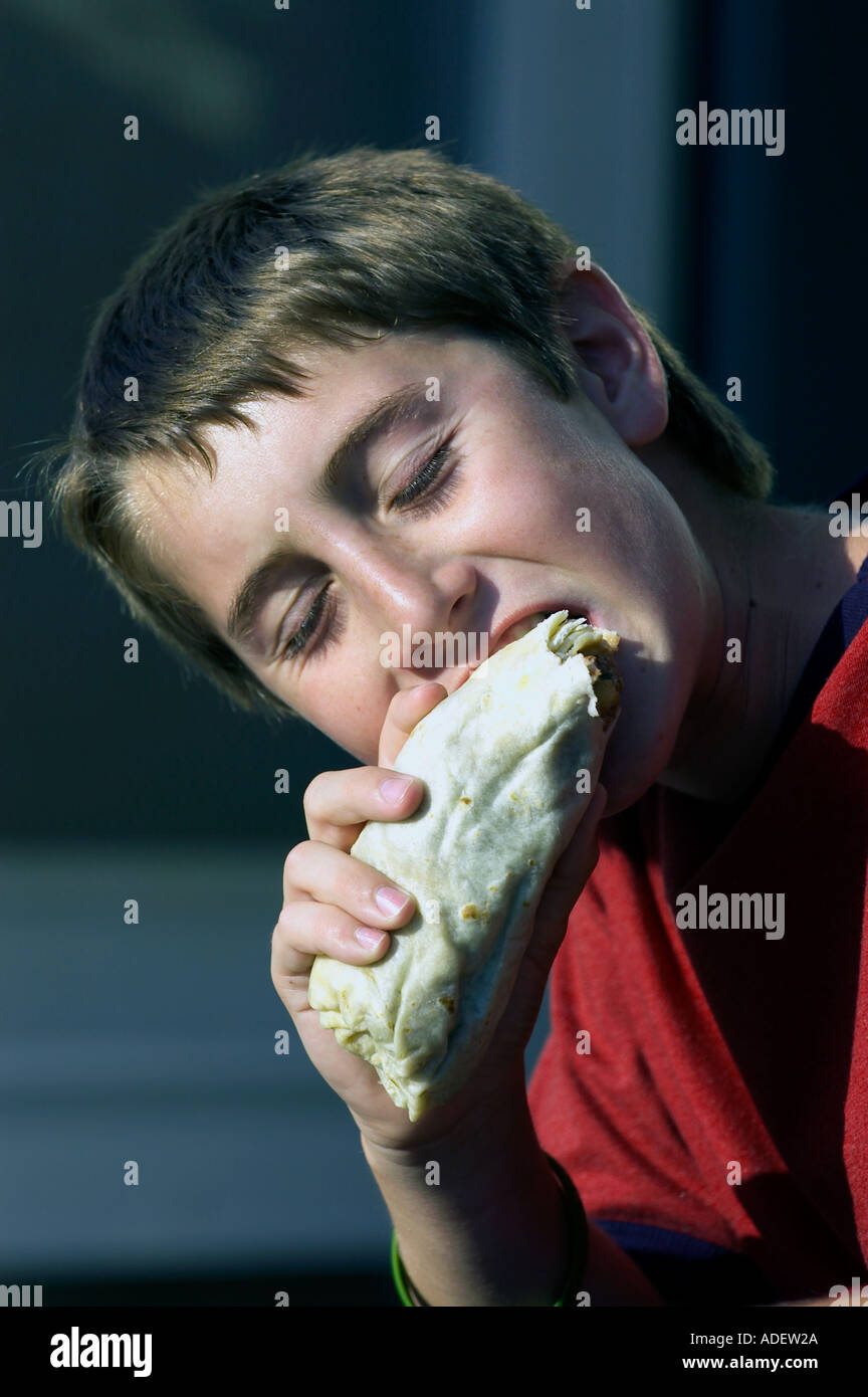 Boy eating burrito hi-res stock photography and images - Alamy