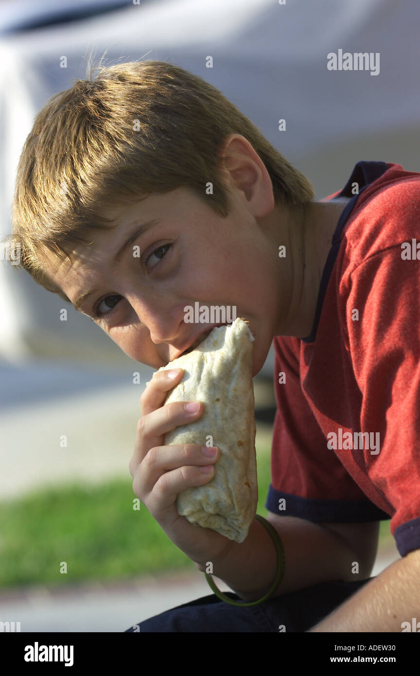 boy eating a burrito Stock Photo - Alamy