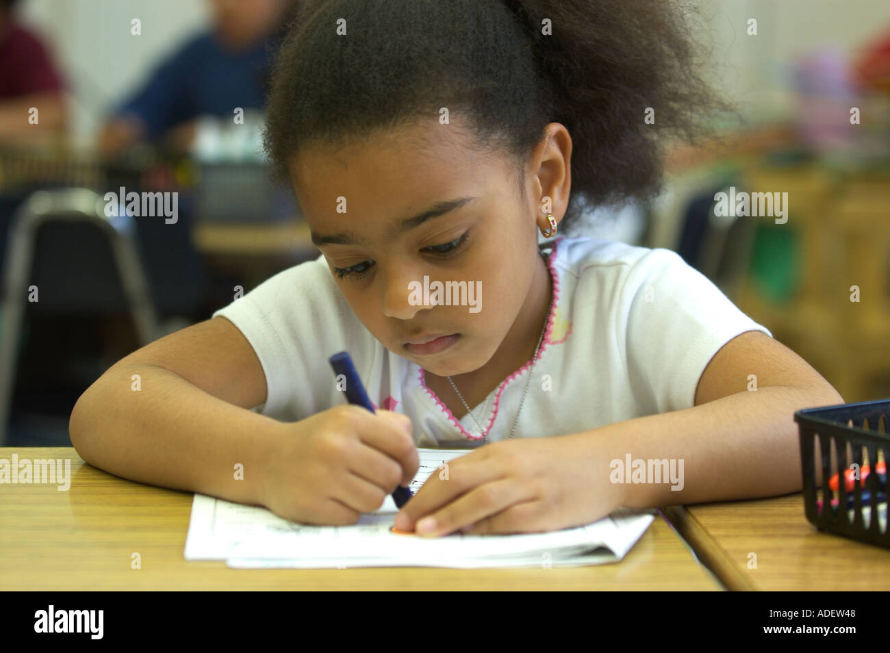young student writing in class Stock Photo - Alamy