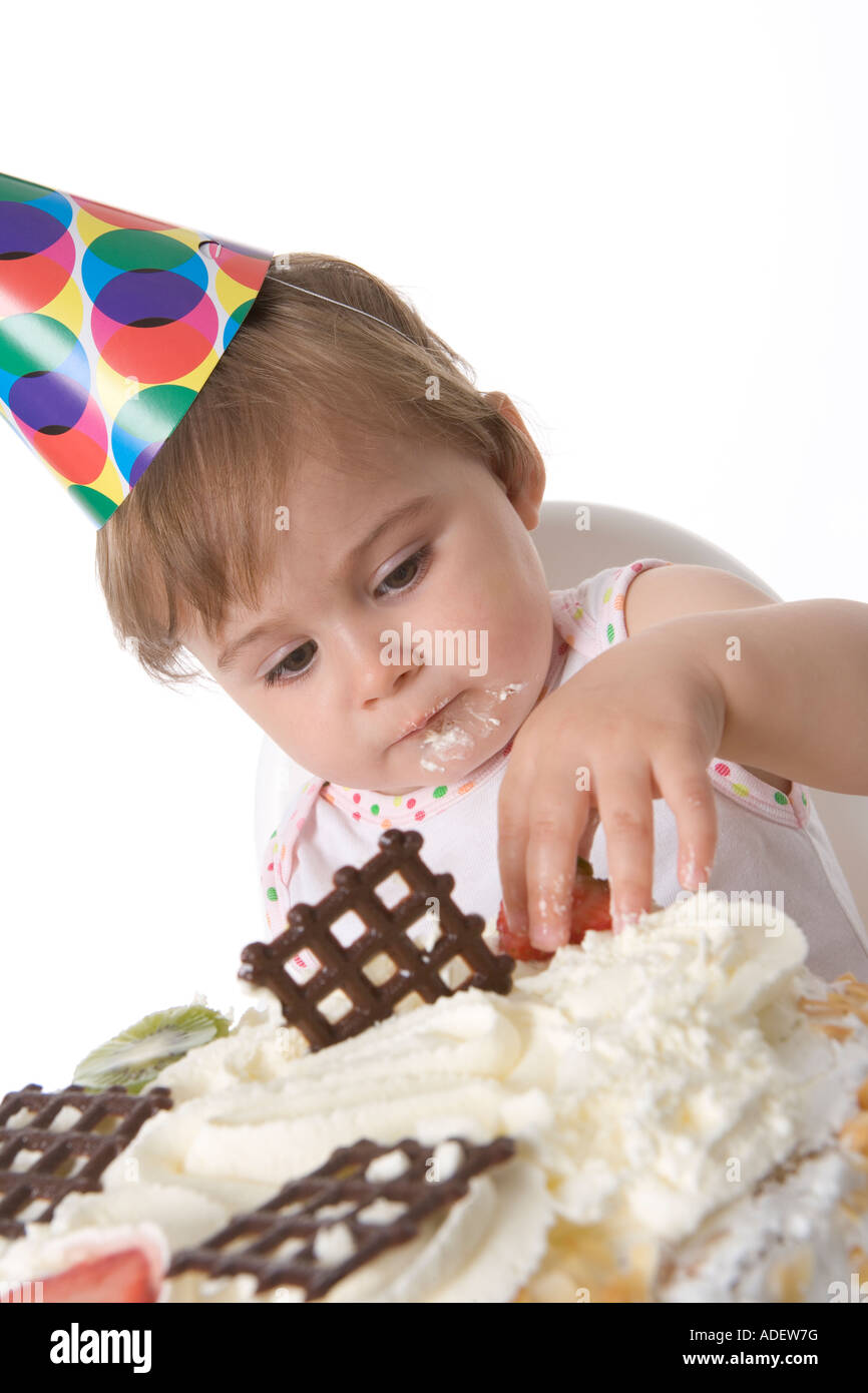 One year old baby girl eating from her birthday cake Stock Photo - Alamy