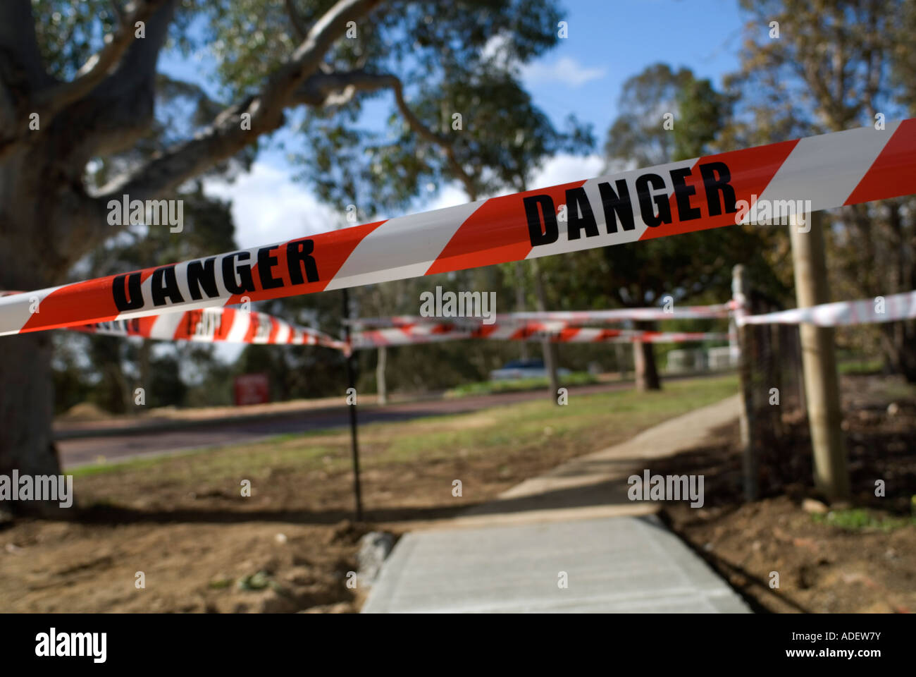 footpath under repair, with safety tape barrier Stock Photo - Alamy