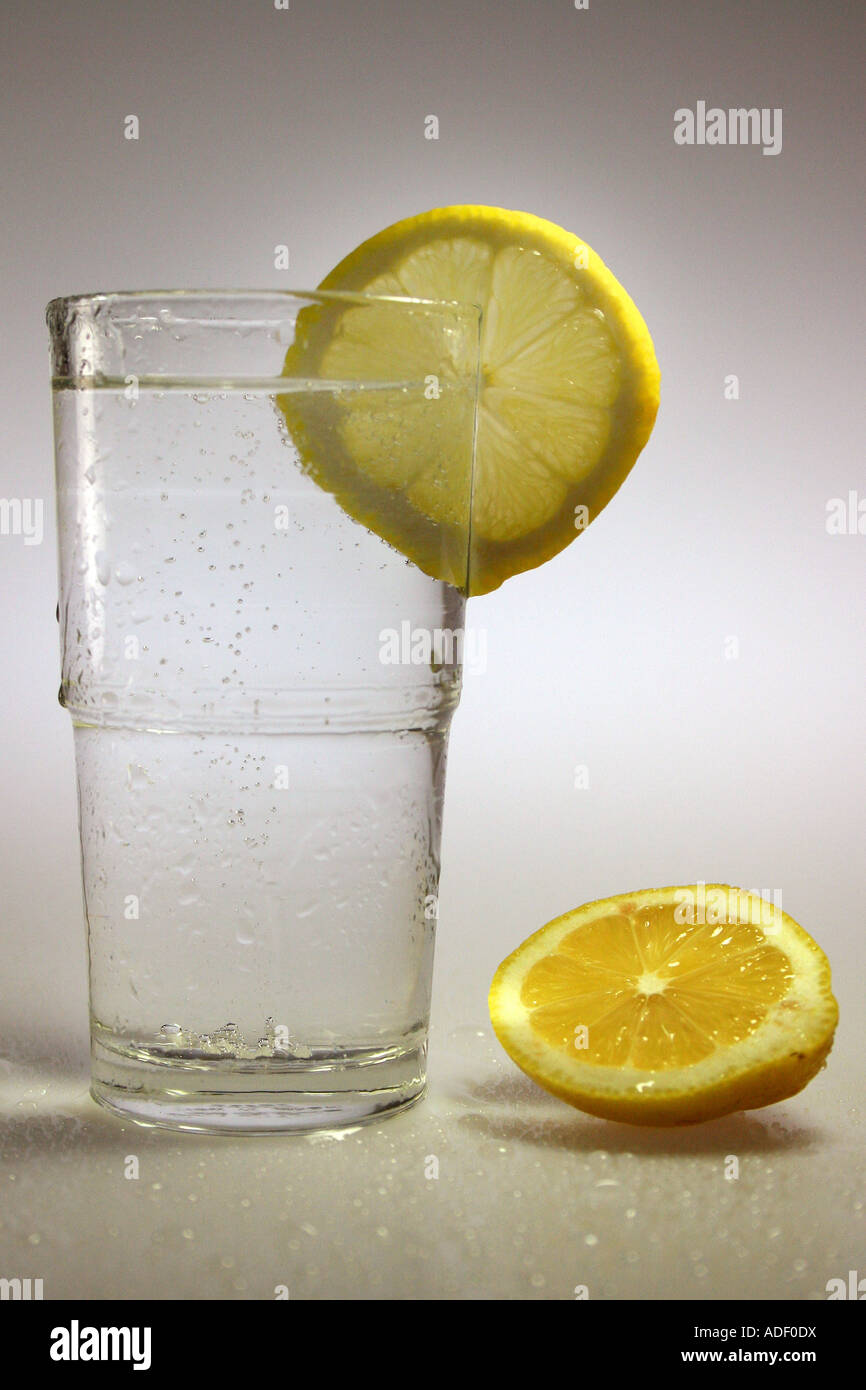glass with water and a twist of lemon Stock Photo - Alamy