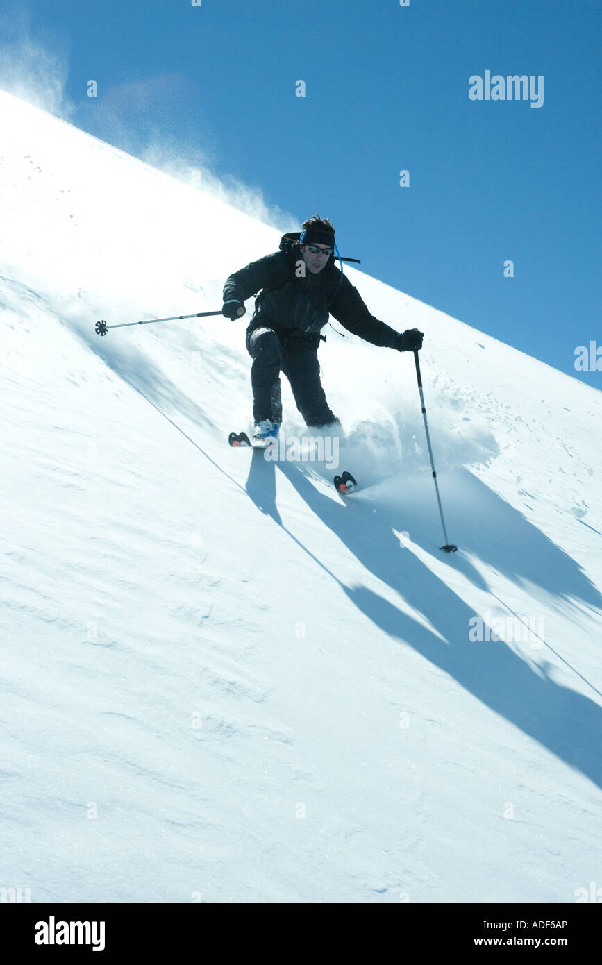 Skier descending steep slope hi-res stock photography and images - Alamy