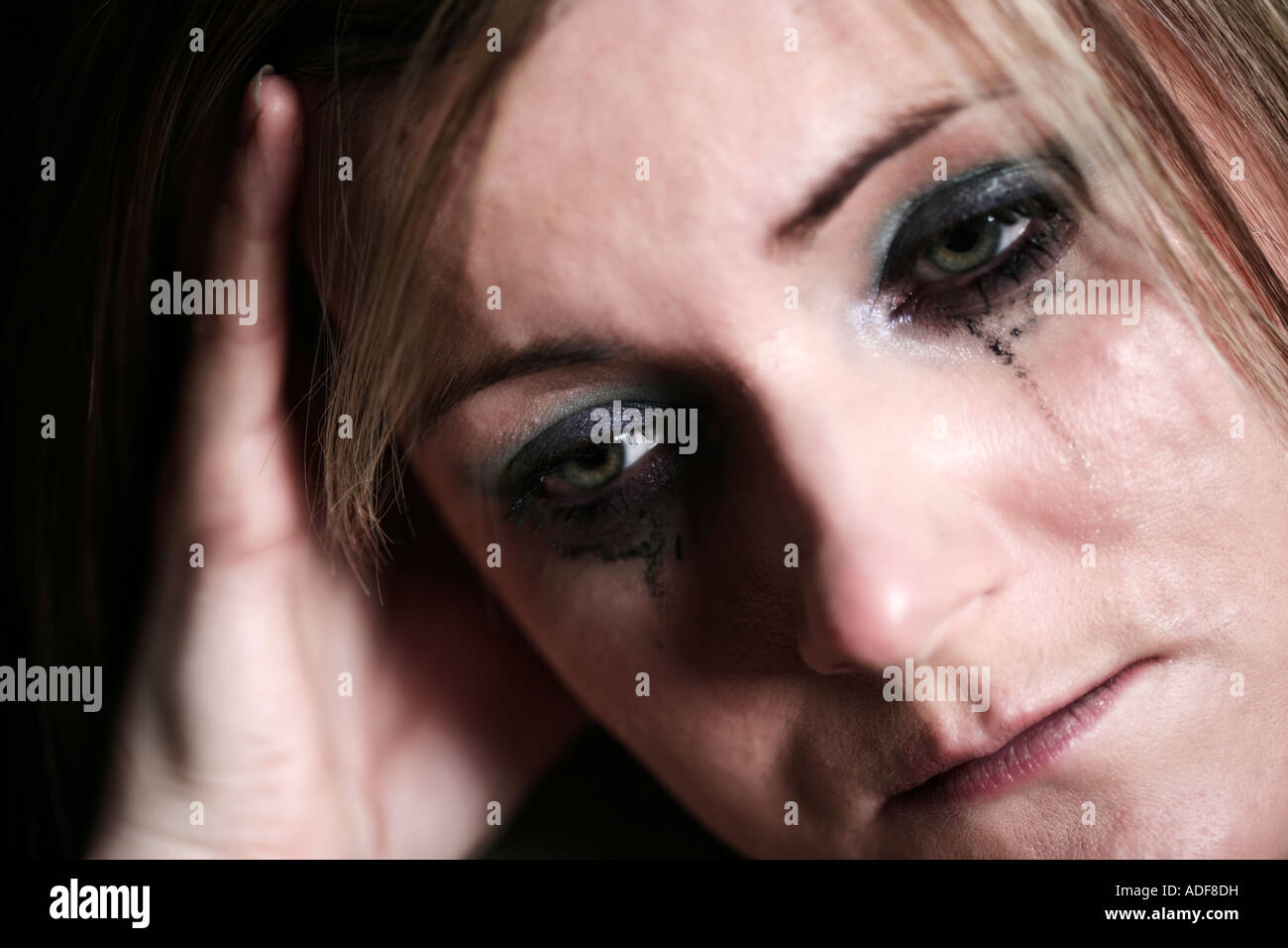 A twenty something female obviously very upset with makeup running down ...