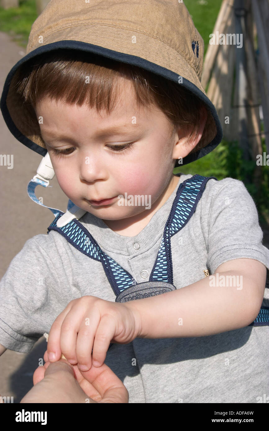 Young boy taking hold of something Stock Photo - Alamy