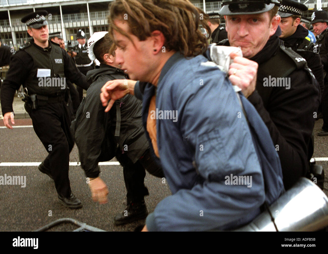 Police officers chasing demonstrator through the streets during ...