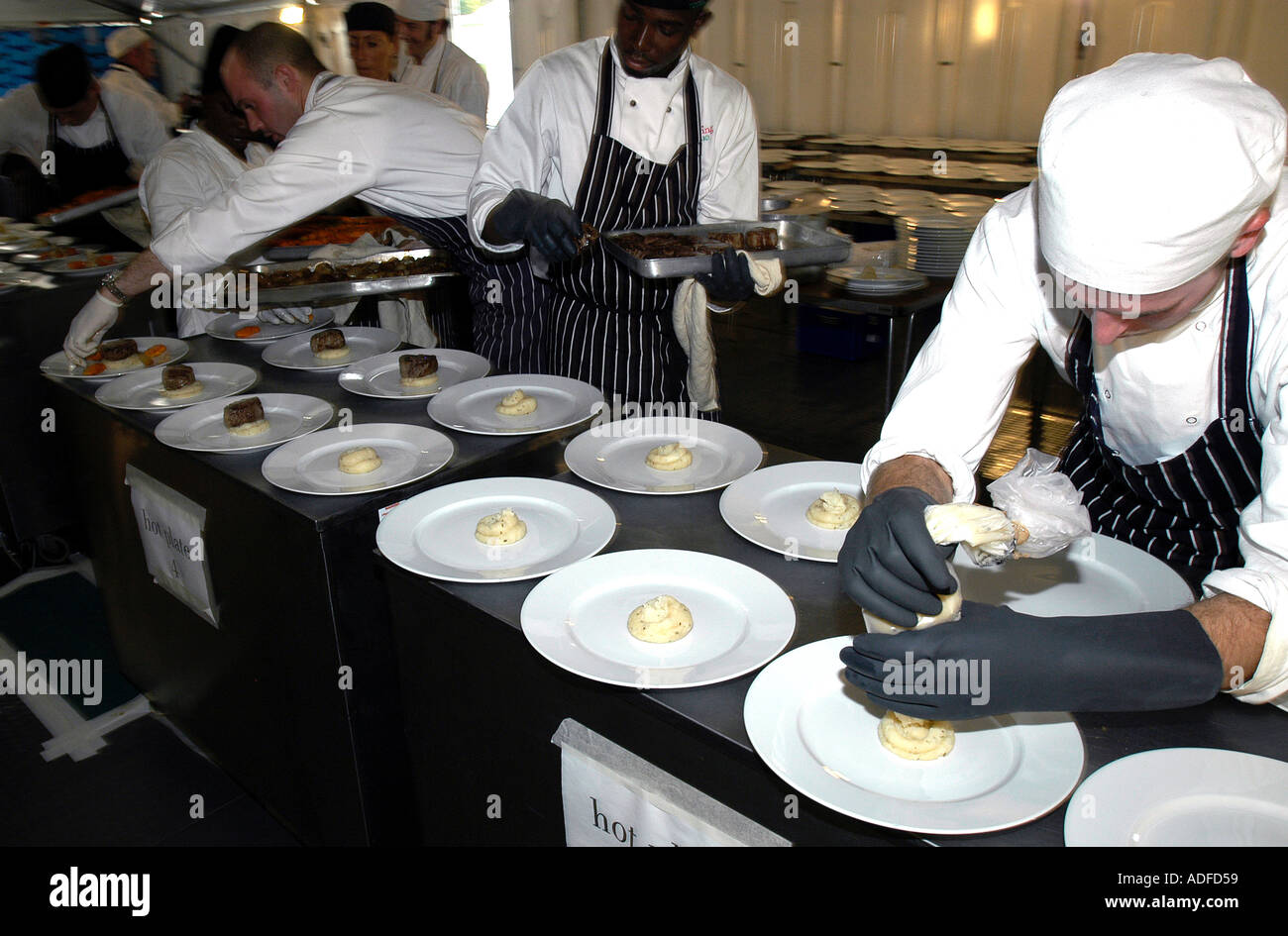 Chefs working in large kitchen preparing banquet dinner Stock Photo - Alamy