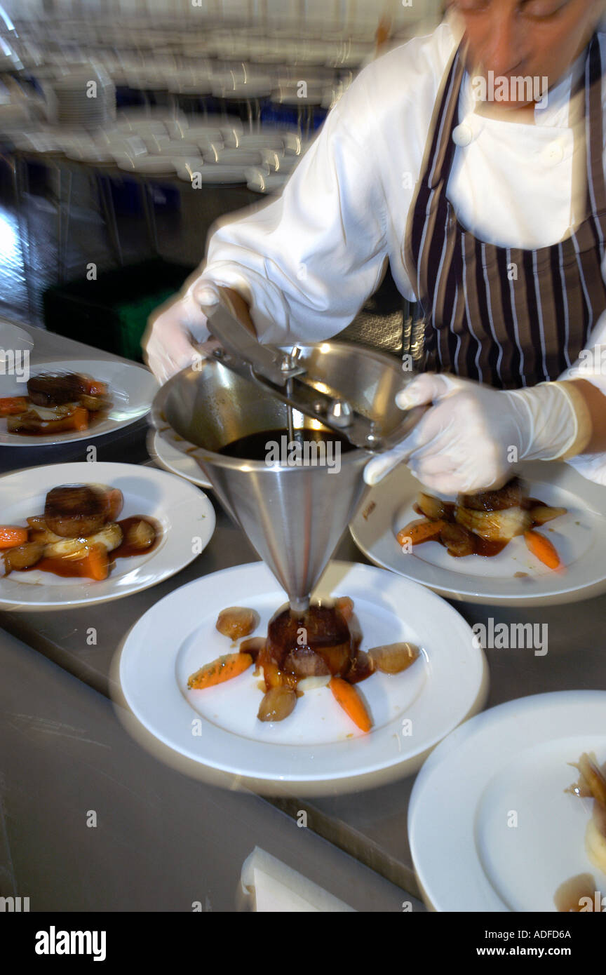 Chefs working in large kitchen preparing banquet dinner Stock Photo - Alamy