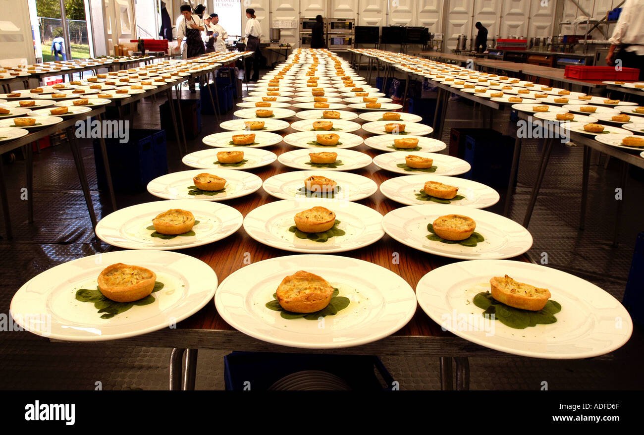 Plates of food ready for serving at banquet for hundreds of guests ...