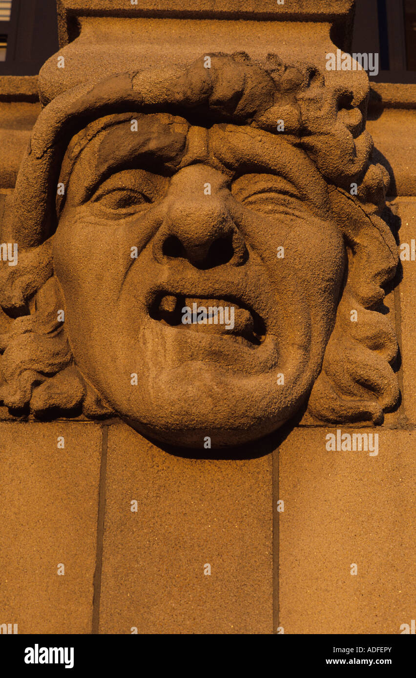 Gargole on side of building at sunset grotesque expression along the ...