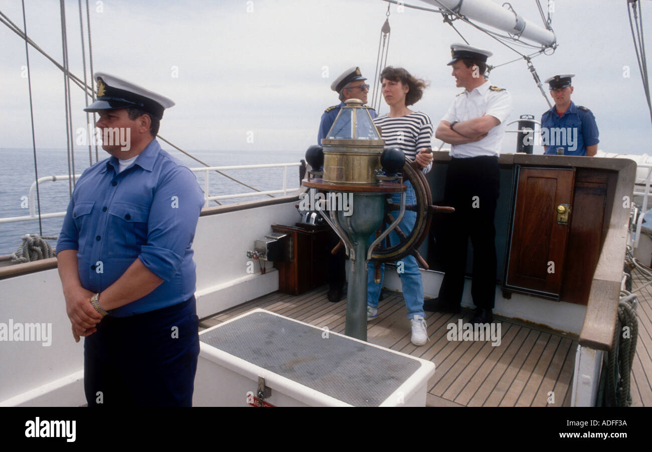A crew member takes the wheel of the 1971 British sail trainig brig ...