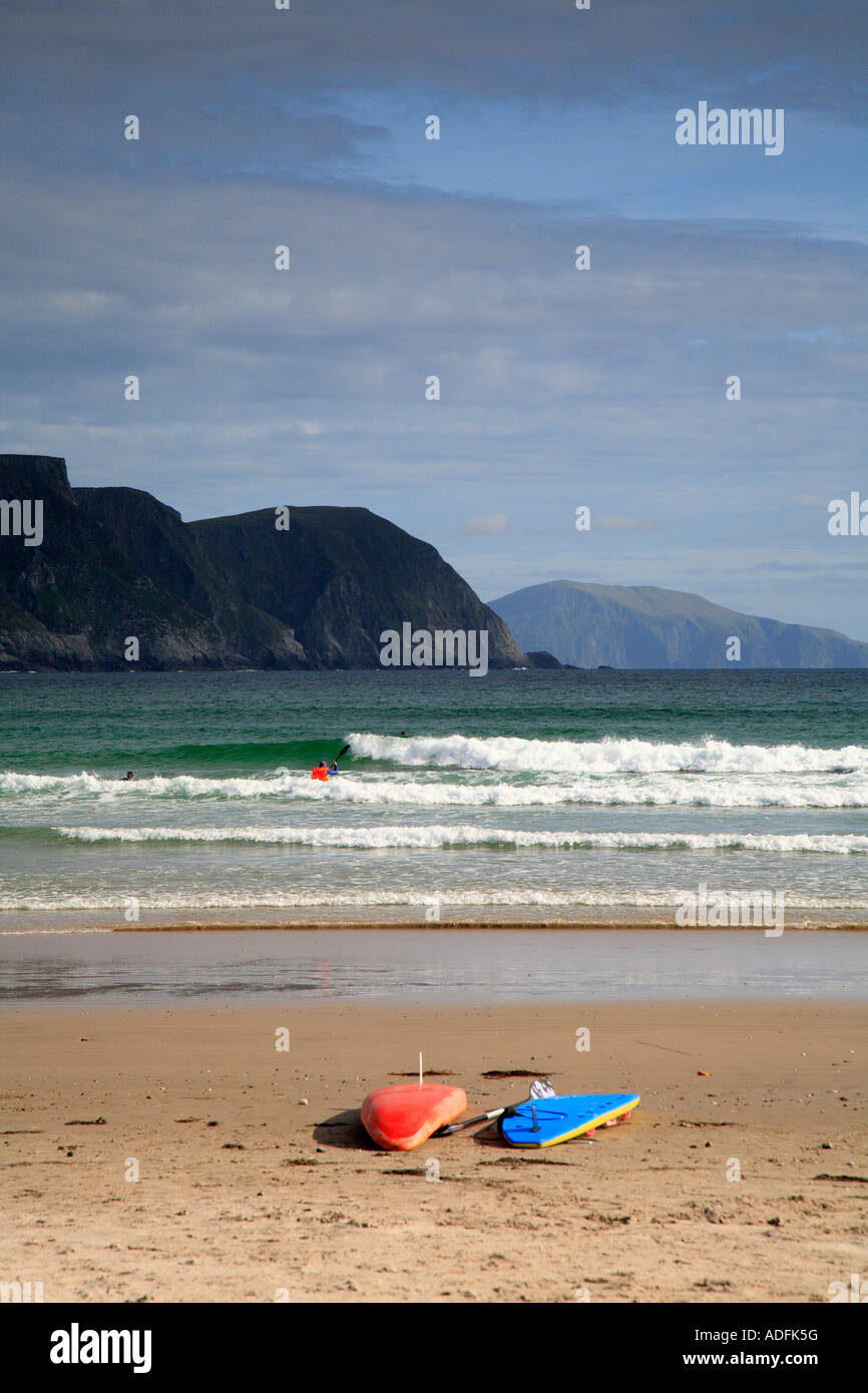 Surfers on Keel beach below Minaun cliffs, Achill Island, County Mayo ...