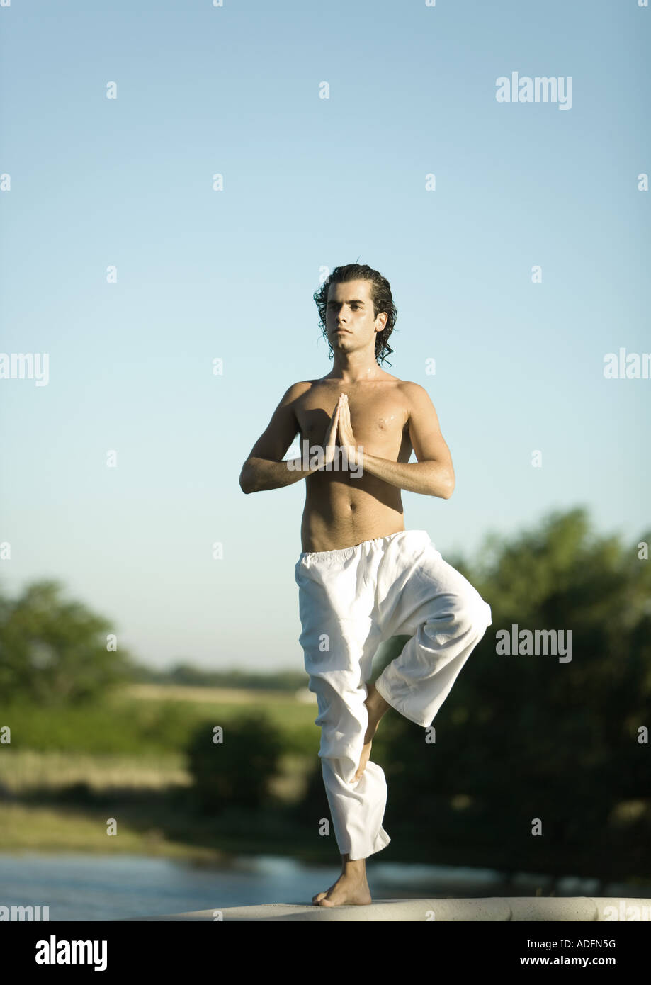 Man doing yoga pose outdoors Stock Photo - Alamy