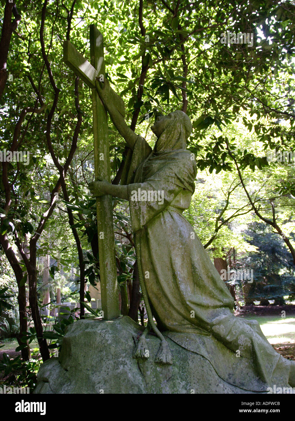 Gravestone with cross and female figure Stock Photo - Alamy