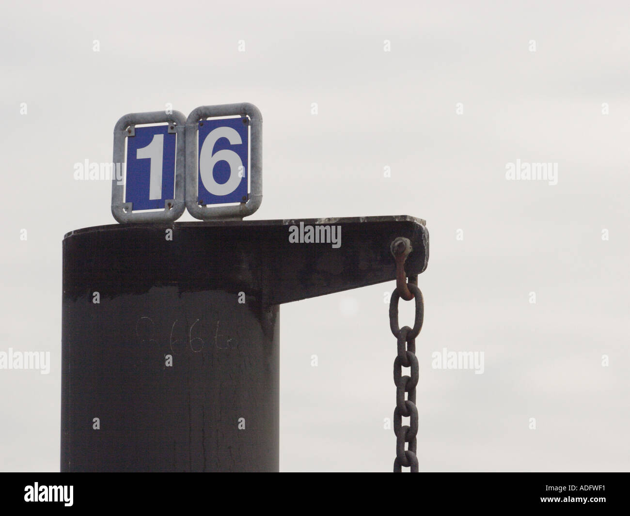 Number Sixteen 16 sign on top of bollard Stock Photo - Alamy