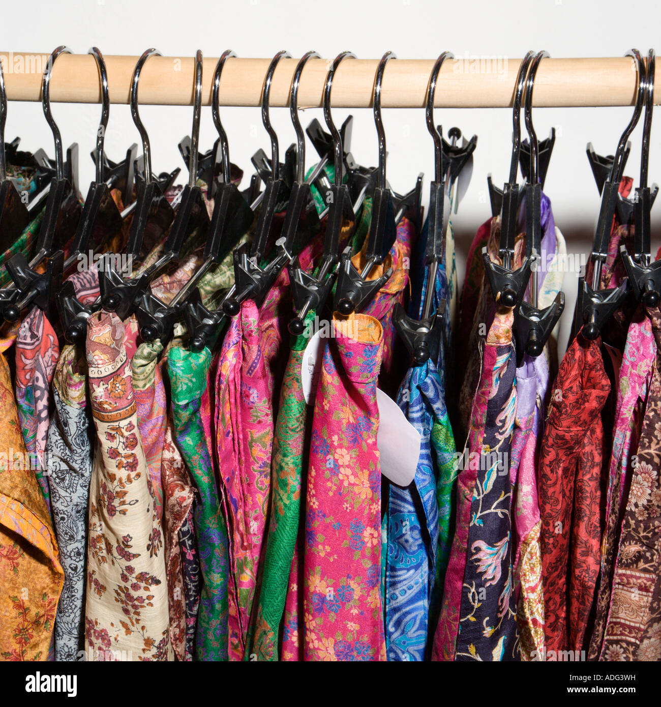 Colorful clothes hanging on rack Stock Photo - Alamy