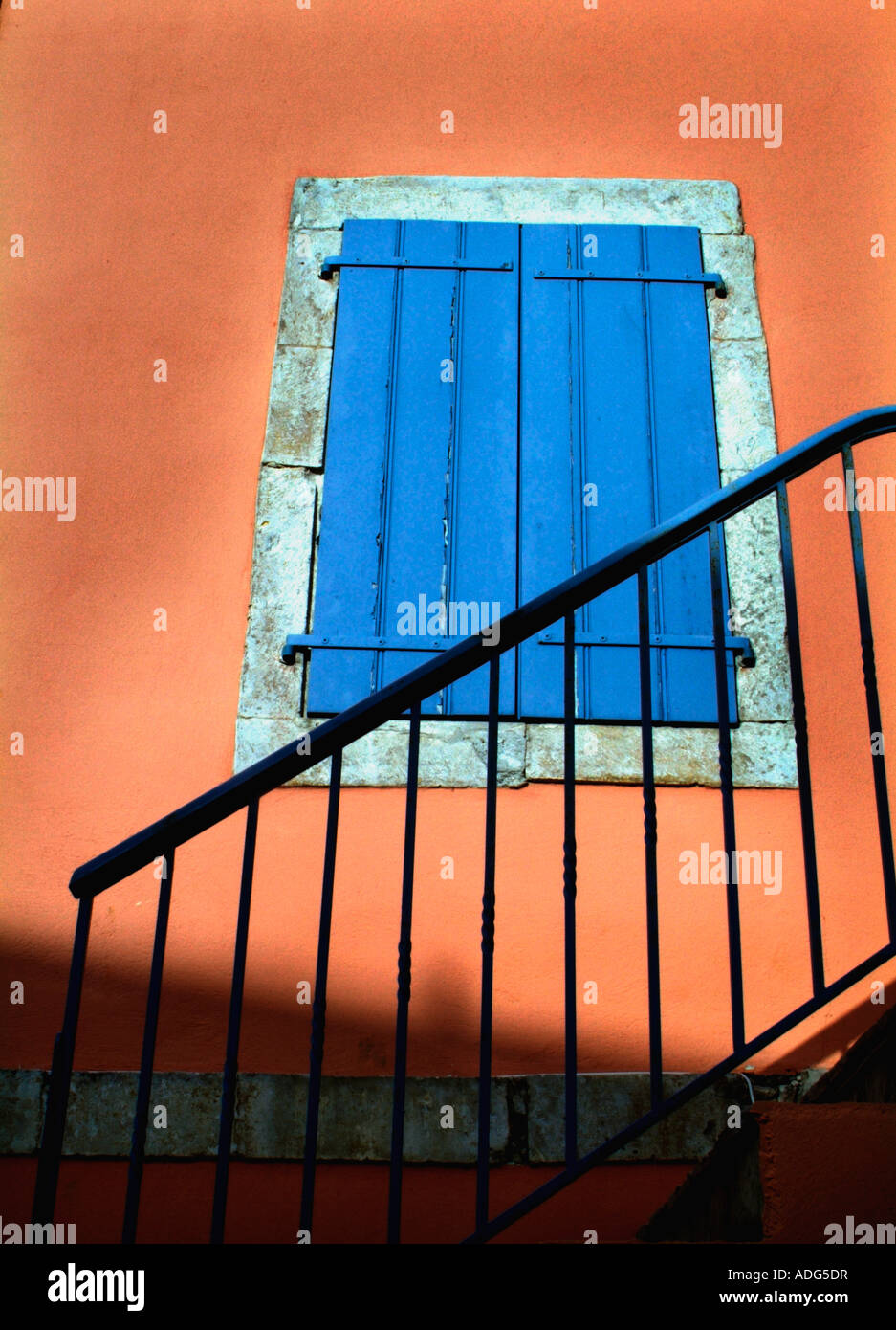 blue shutter covering window in front of wrought iron bannister Stock ...