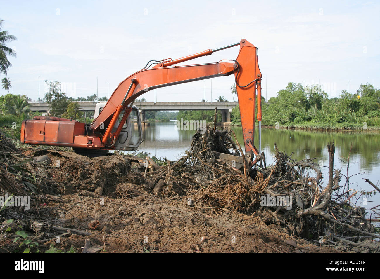 An excavator clearing debris Stock Photo - Alamy