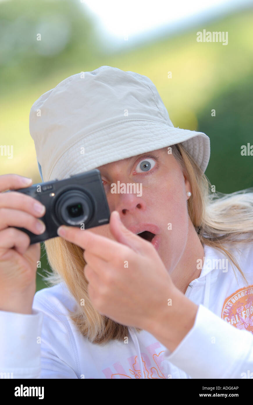 young woman taking photograph shocked Stock Photo - Alamy