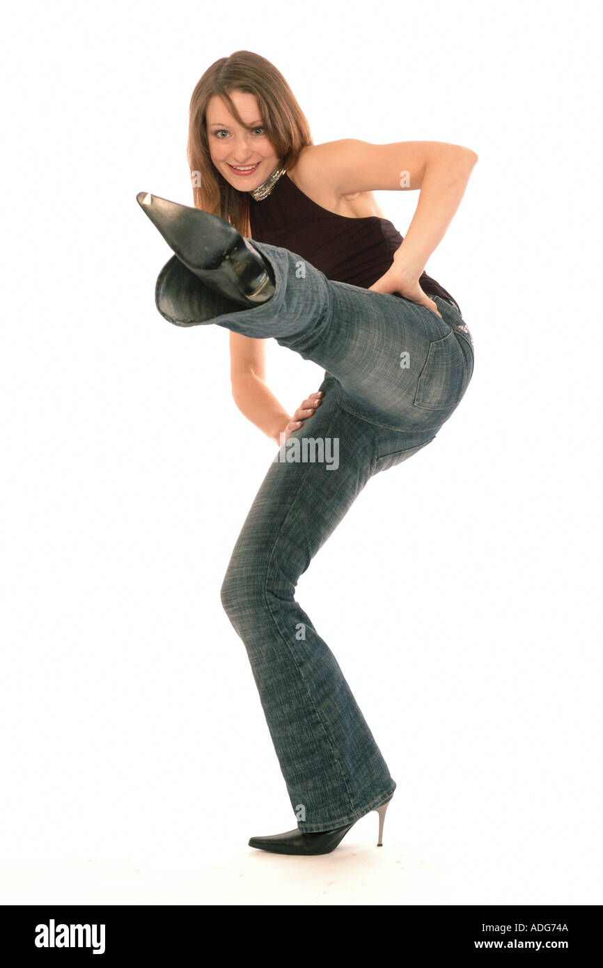 Model in high key studio kicking Stock Photo - Alamy