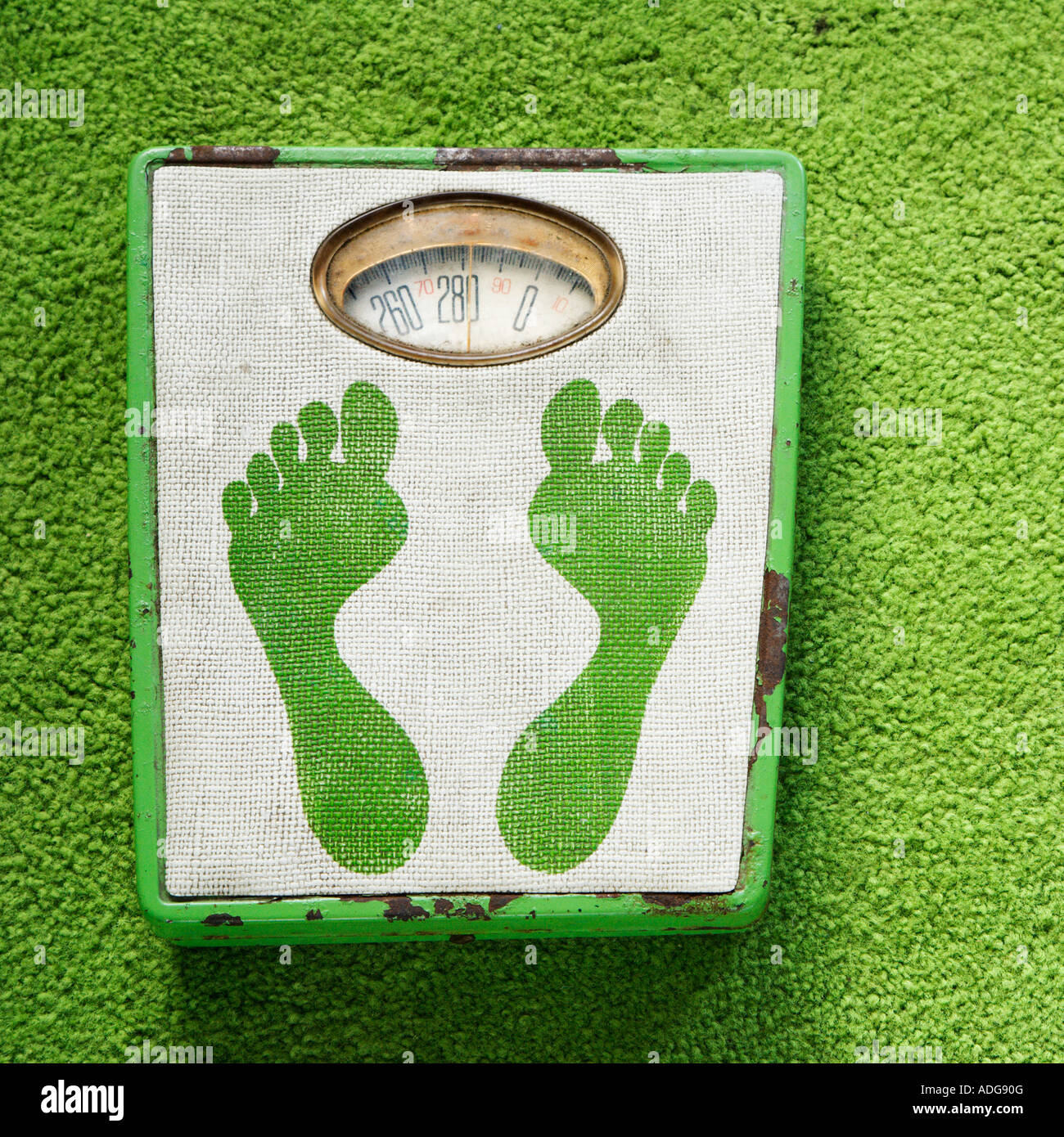 Vintage foot scale with green footprints against green carpet Stock ...