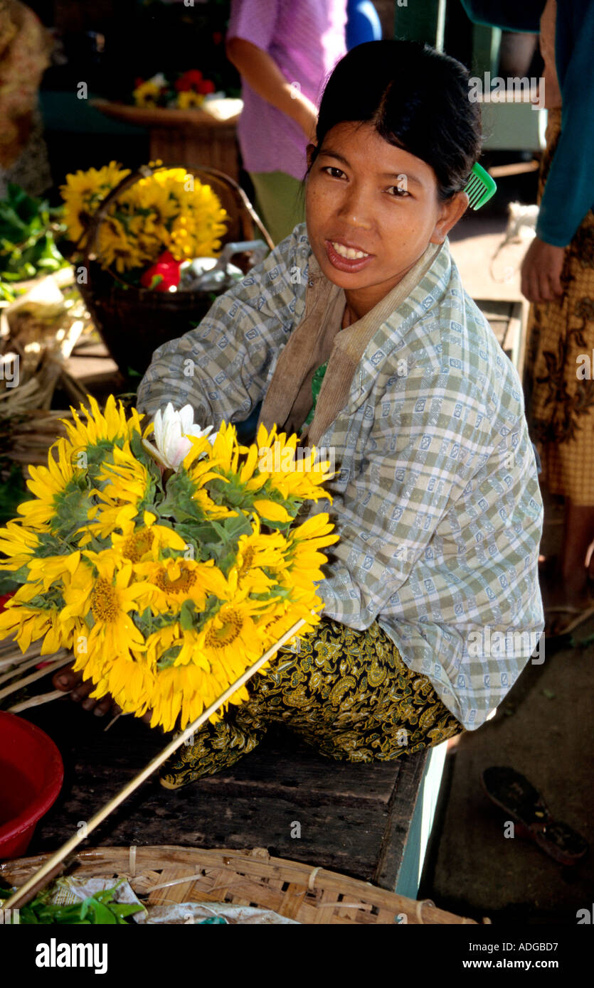 Flower stall Burmese woman selling yellow flowers to tourist in Burma ...