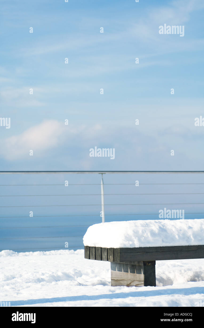 Snow-covered bench overlooking lake Stock Photo - Alamy