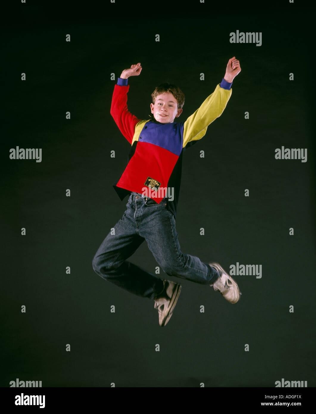 Teenage boy leaping into the air Stock Photo - Alamy