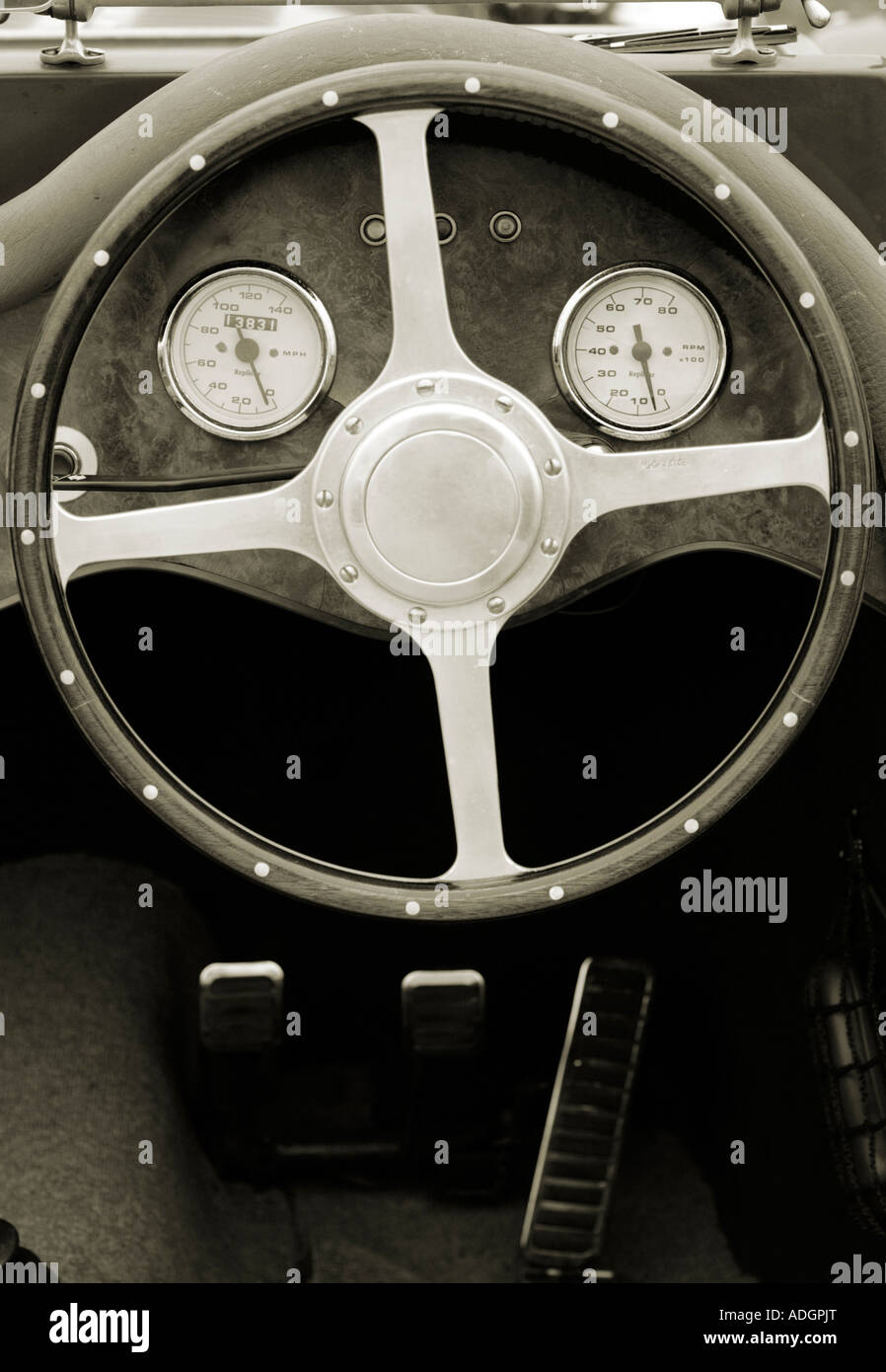 Steering wheel dashboard and control pedals on veteran British sports ...