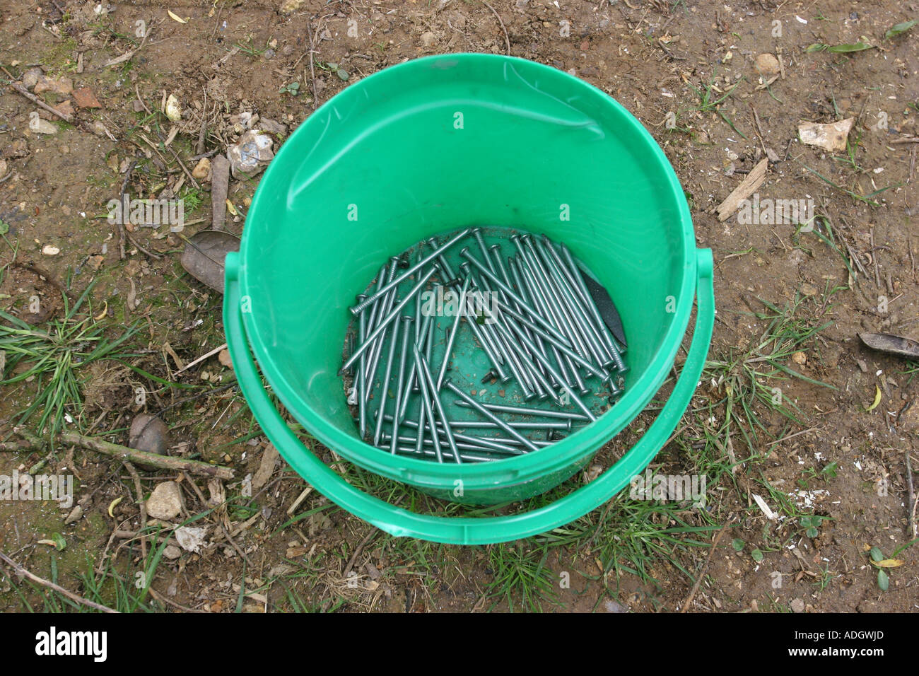 Bucket filled with nails Stock Photo - Alamy