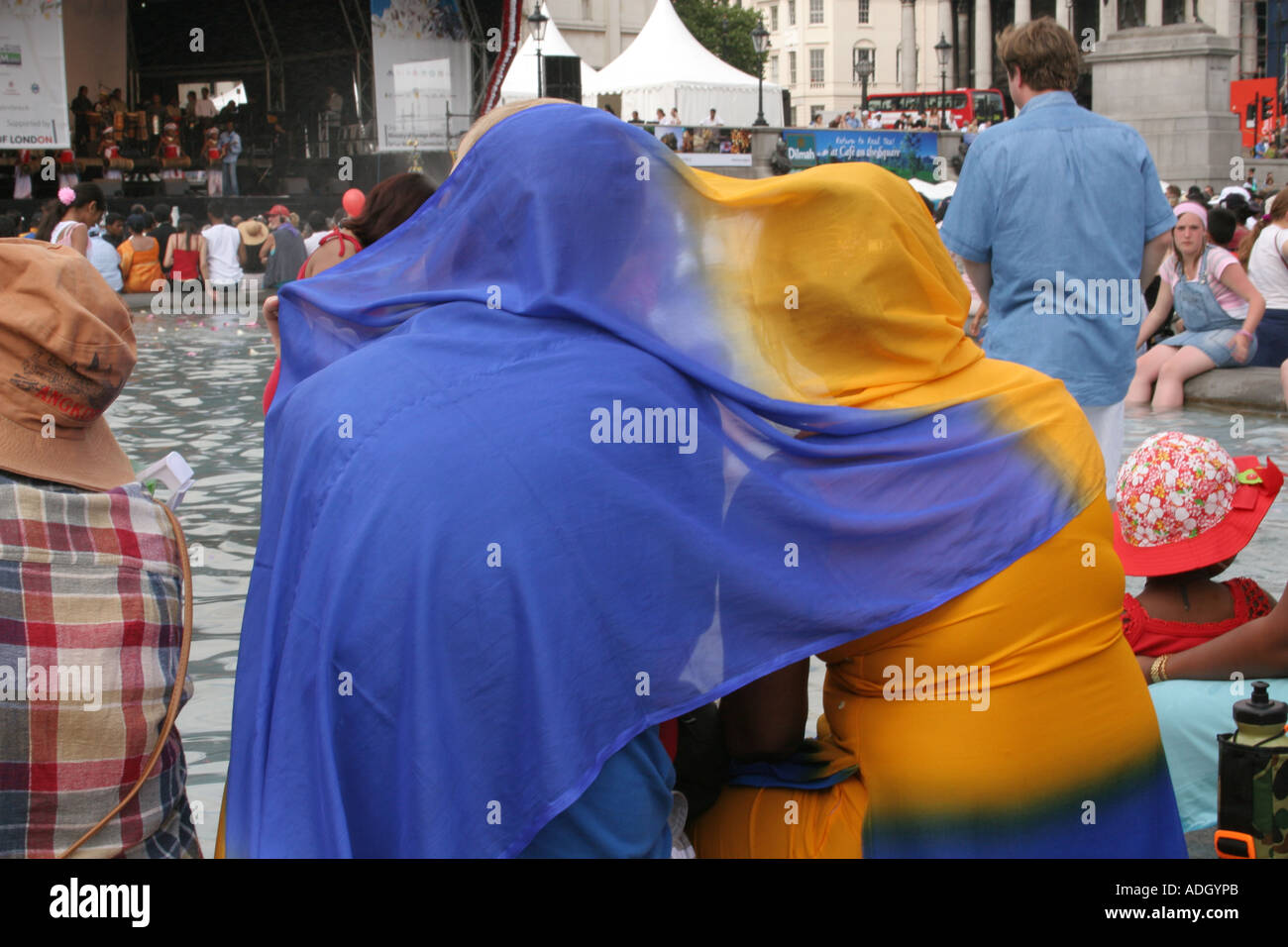 Two people huddle together at Trafalgar square London Stock Photo - Alamy