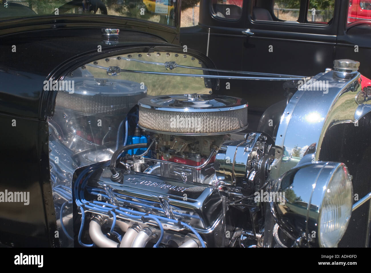 Close up of chromed Chevy engine in a black street rod Stock Photo - Alamy
