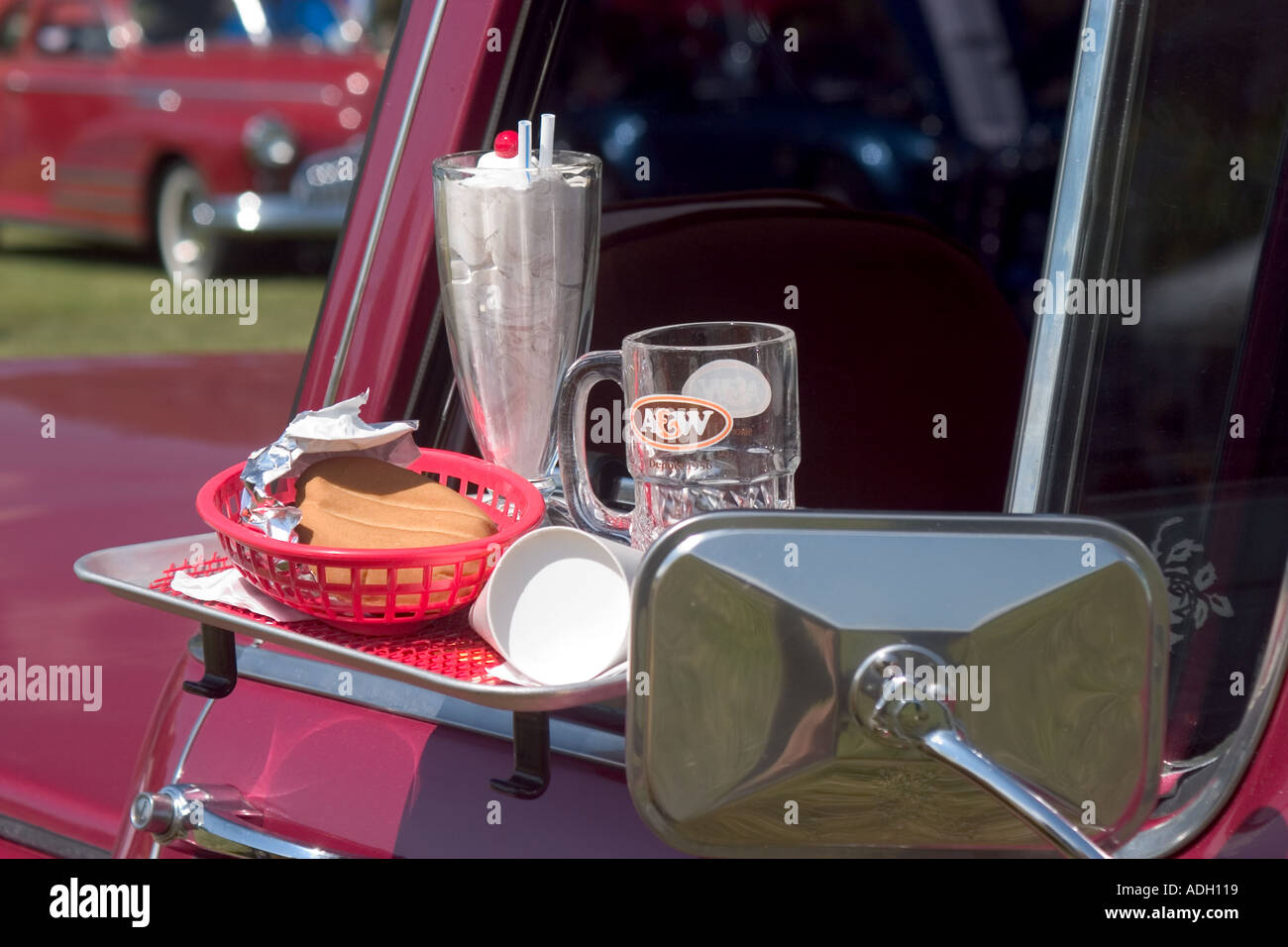 Drive in food tray with food on window of street rod Stock Photo - Alamy