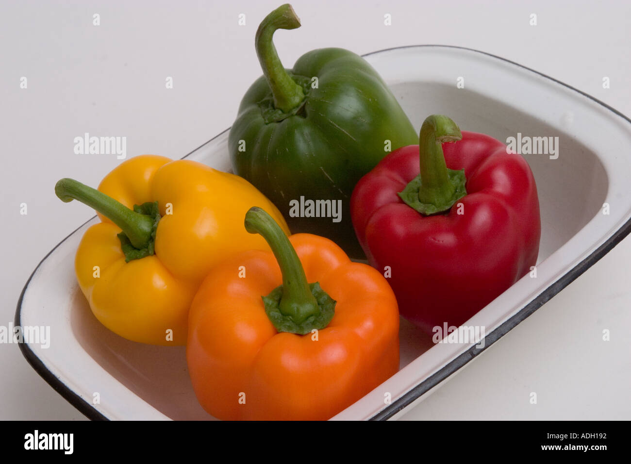 Four Colourful bell peppers in tray red yellow green orange Stock Photo ...