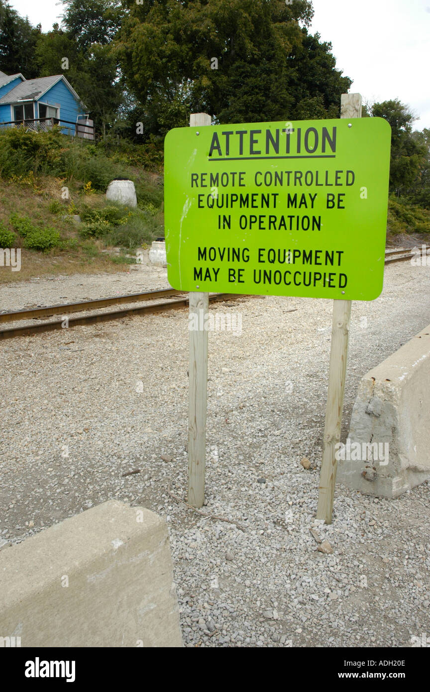 Warning sign on Railroad train bed about remote controlled trains which ...