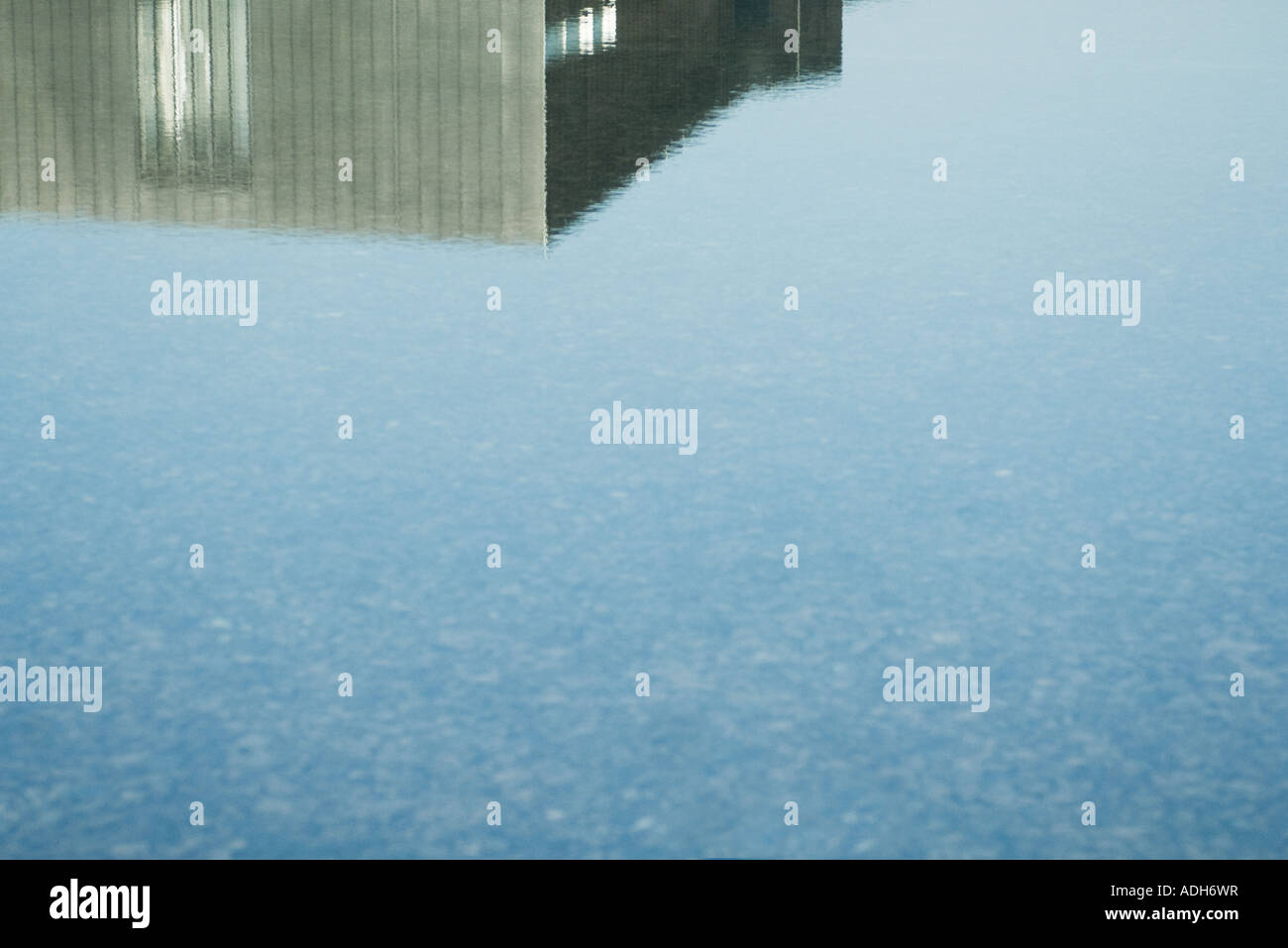 Building reflected in surface of water Stock Photo - Alamy