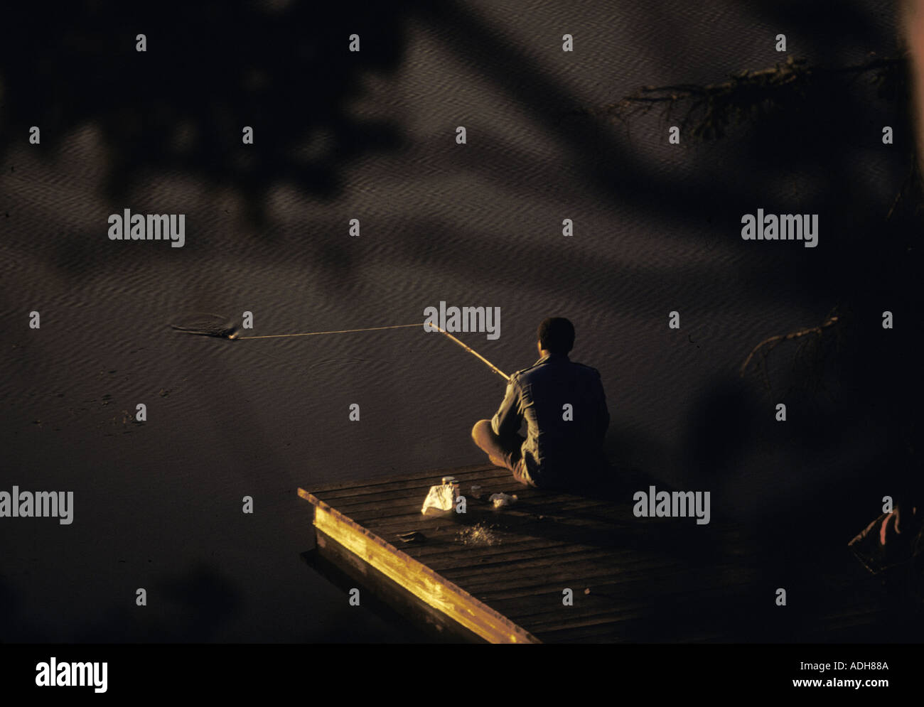 Man Spinfishing from Dock at Delong Lake SC Alaska Stock Photo - Alamy
