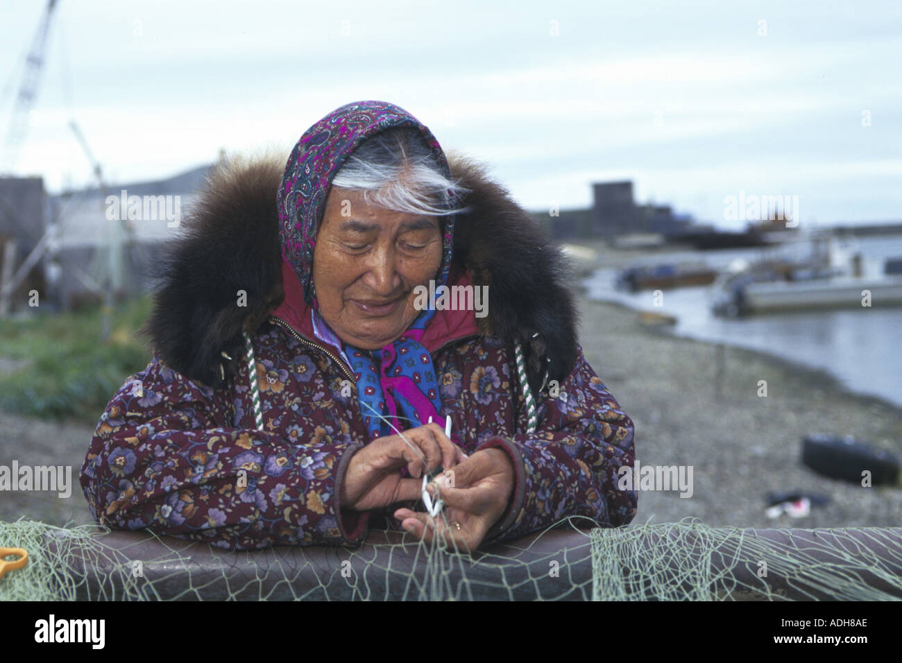 Native woman mending fishing net Selawik Kotzebue WE AK summer portrait ...