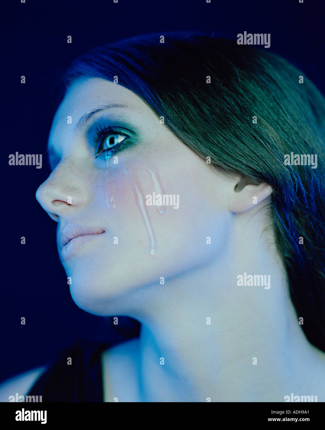 young woman s face with tear running down cheek Stock Photo - Alamy