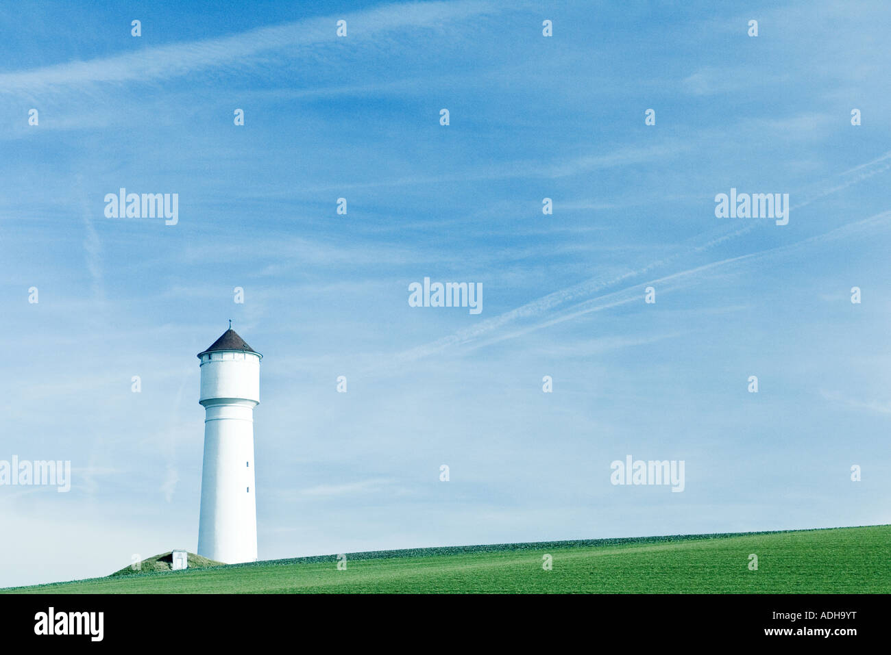 Tower in green field Stock Photo - Alamy