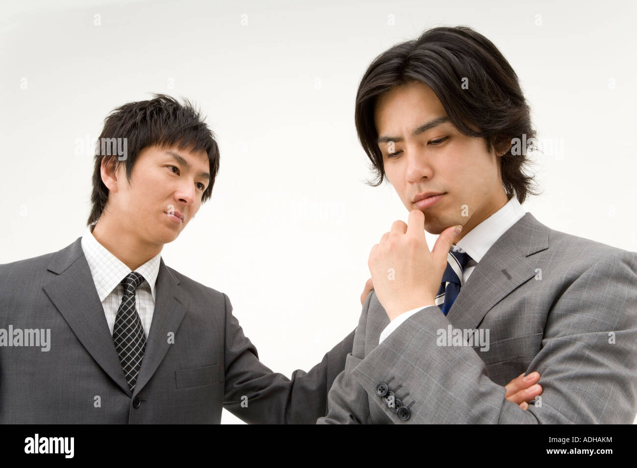 Businessman consoling his colleague Stock Photo - Alamy