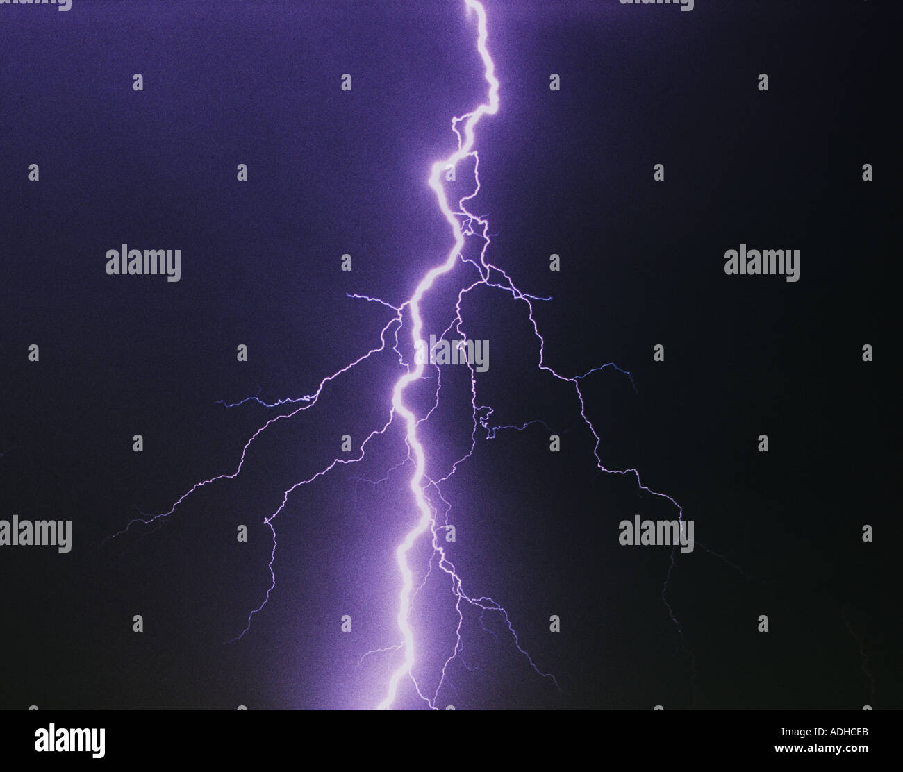 Lightning bolt splitting night sky Stock Photo - Alamy