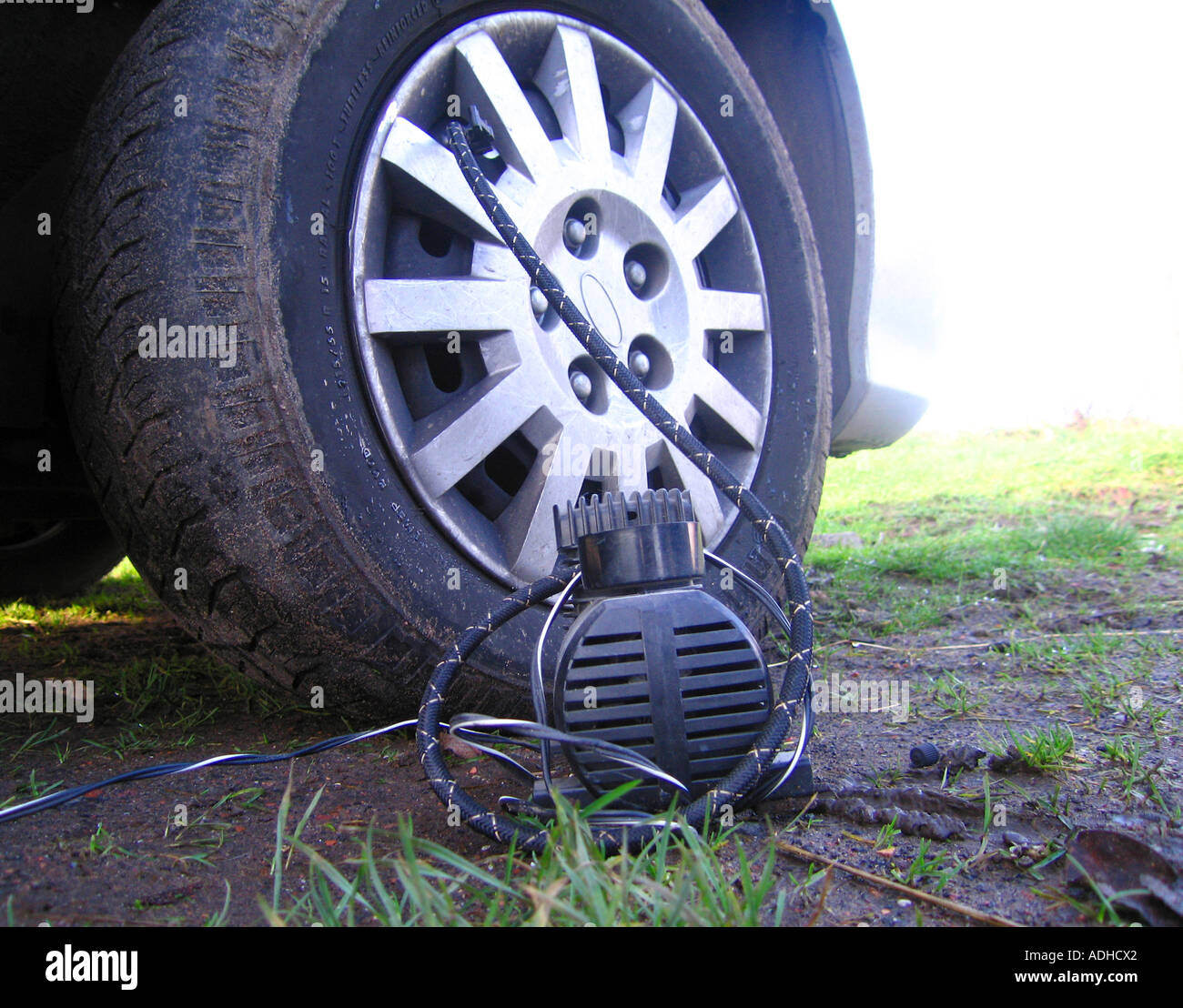 Car tyre being inflated with portable 12 volt compressor Stock Photo ...
