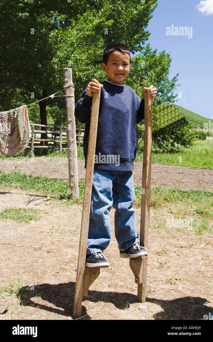 Boy walking on stilts hi-res stock photography and images - Alamy