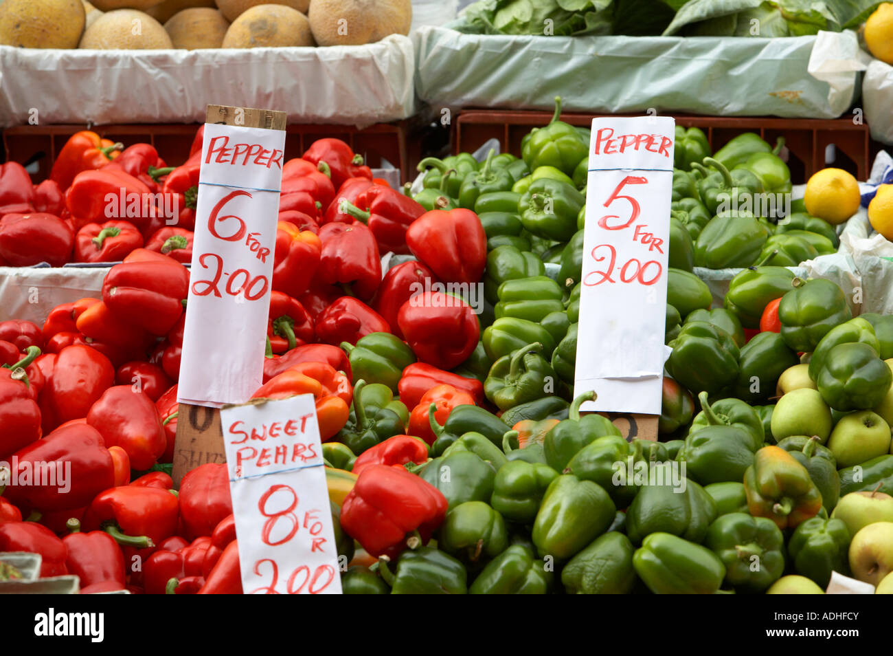 red and green peppers on fruit and veg stall with signs in english and ...